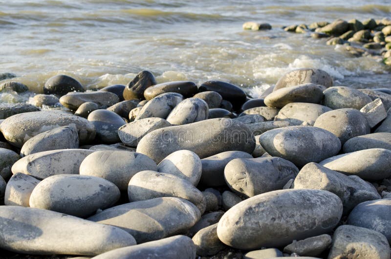 Stones on the shore stock photo. Image of coastline - 103855810