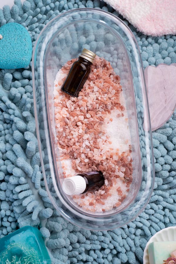 Natural Spa Set with Salt, Healing Mud and Soap on Blue Bath Mat. Flay ...