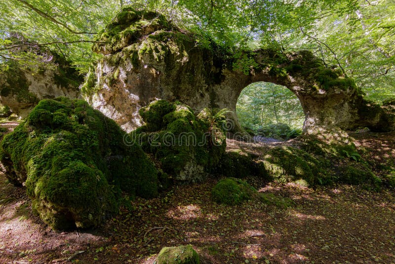 Natural Stone Arch in the Forest with Moss on the Rocks Stock Image ...