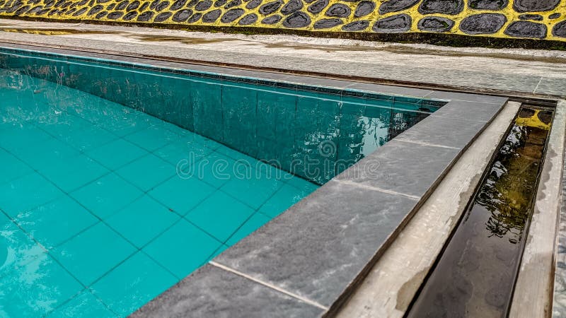Natural Stone Floor by the Poolside with Light Blue Water Stock Photo ...