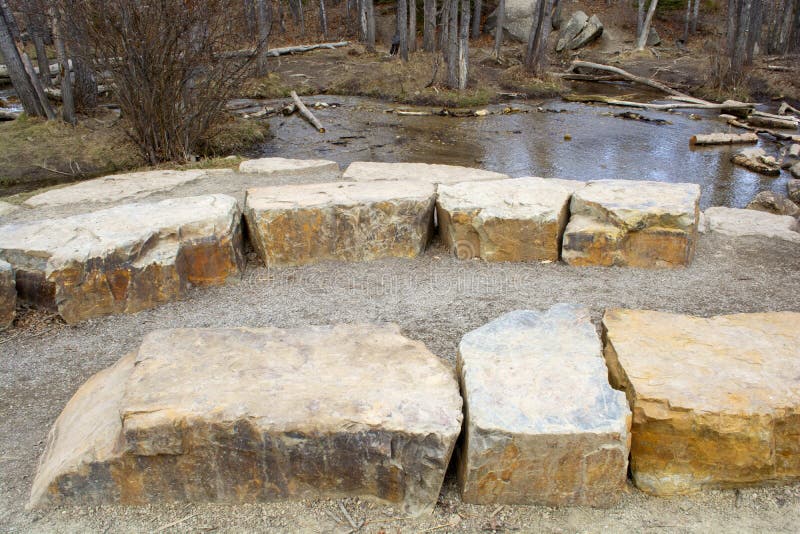 Natural Stone Seating Along Creek in Nature Park. Stock Photo - Image ...