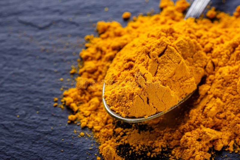 Natural Turmeric Oil in a Glass Bottle with Ground Turmeric Powder and ...