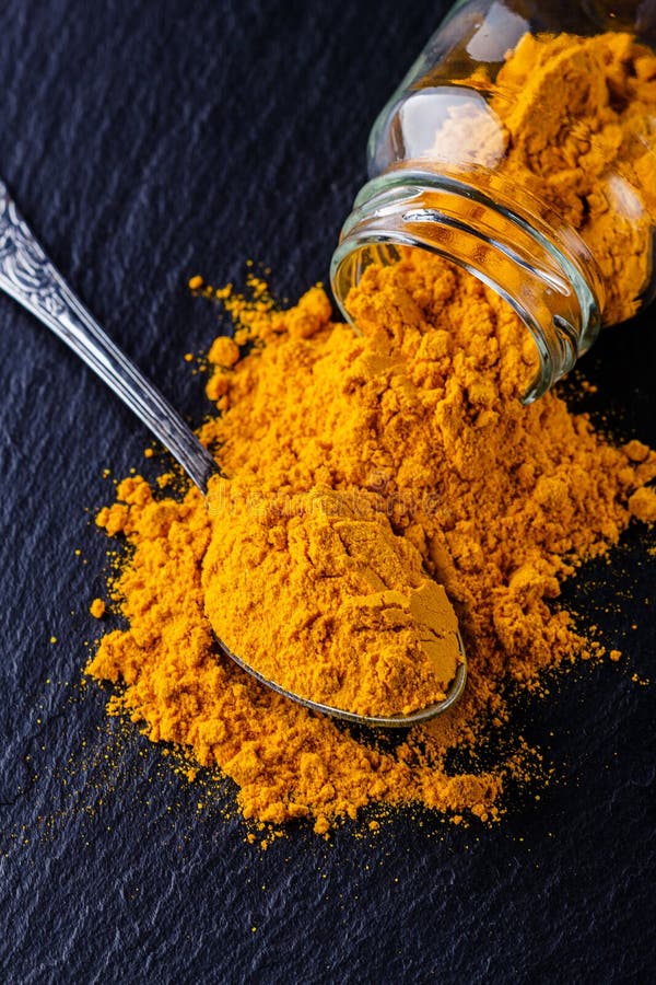 Natural Turmeric Oil in a Glass Bottle with Ground Turmeric Powder and ...