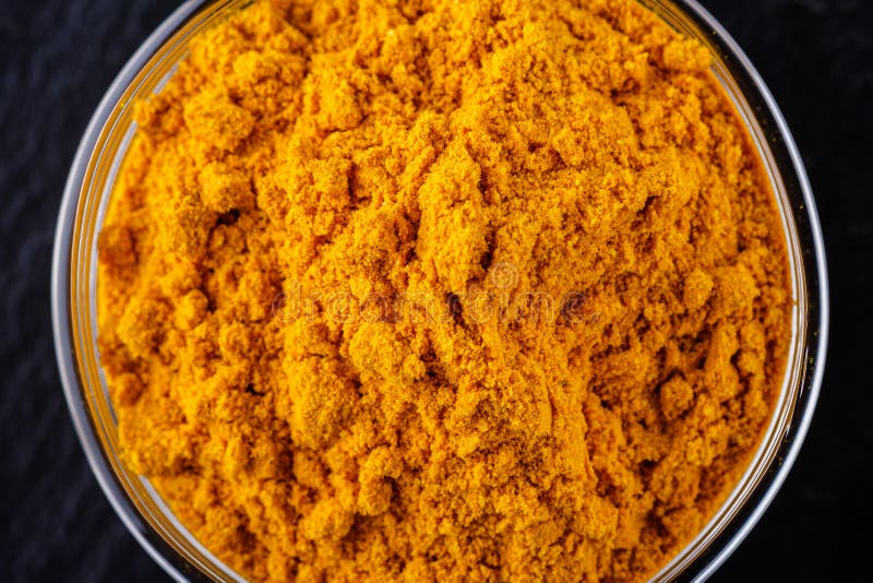 Natural Turmeric Oil in a Glass Bottle with Ground Turmeric Powder and ...