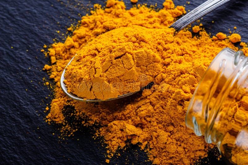 Natural Turmeric Oil in a Glass Bottle with Ground Turmeric Powder and ...