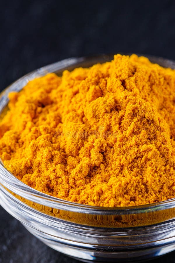 Natural Turmeric Oil in a Glass Bottle with Ground Turmeric Powder and ...