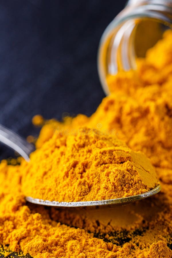 Natural Turmeric Oil in a Glass Bottle with Ground Turmeric Powder and ...
