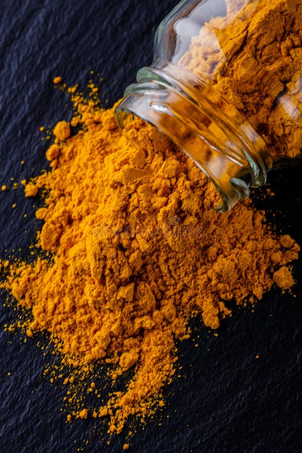 Natural Turmeric Oil in a Glass Bottle with Ground Turmeric Powder and ...