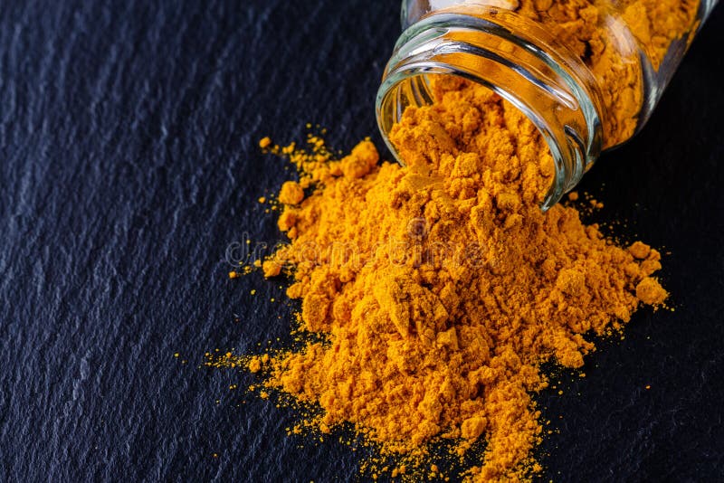 Natural Turmeric Oil in a Glass Bottle with Ground Turmeric Powder and ...