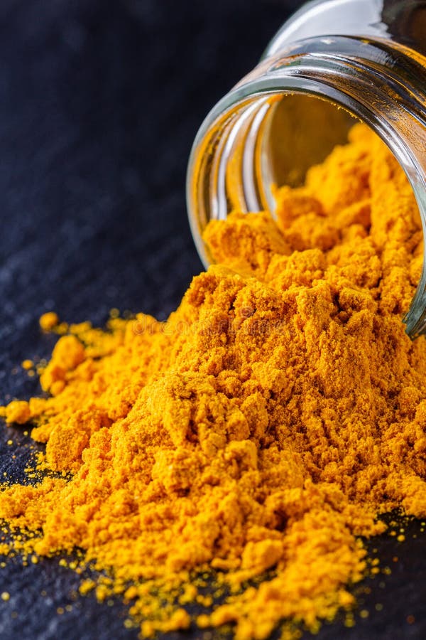 Natural Turmeric Oil in a Glass Bottle with Ground Turmeric Powder and ...