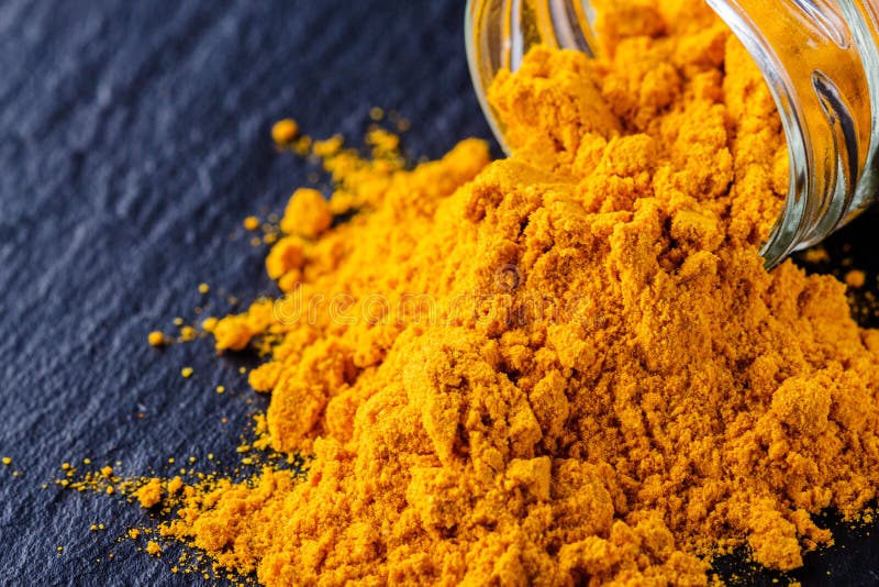 Natural Turmeric Oil in a Glass Bottle with Ground Turmeric Powder and ...