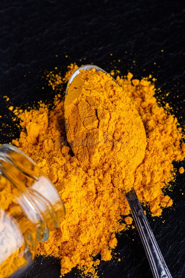 Natural Turmeric Oil in a Glass Bottle with Ground Turmeric Powder and ...