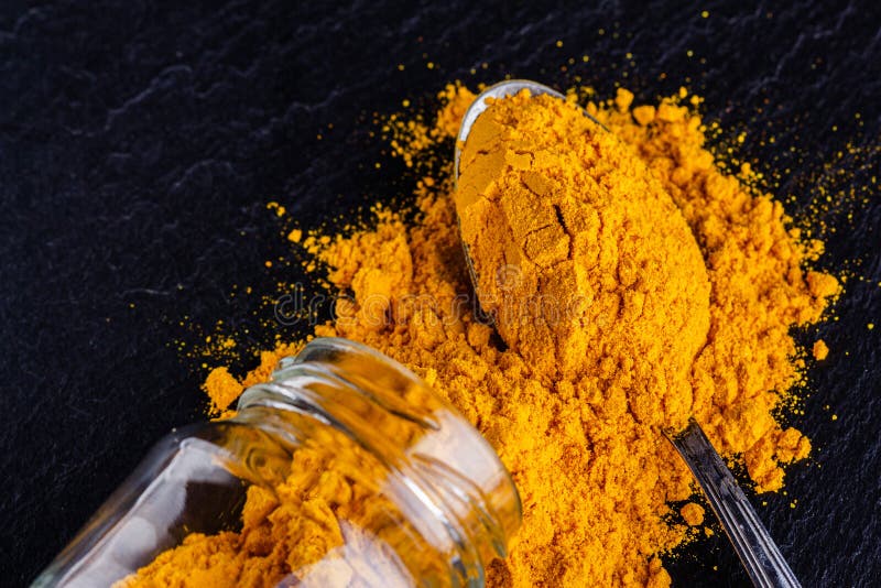Natural Turmeric Oil in a Glass Bottle with Ground Turmeric Powder and ...