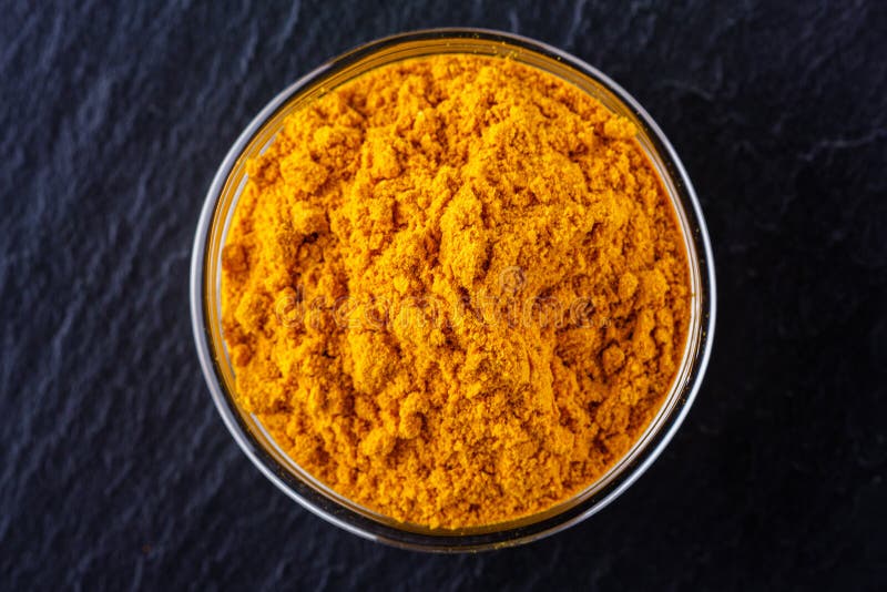 Natural Turmeric Oil in a Glass Bottle with Ground Turmeric Powder and ...