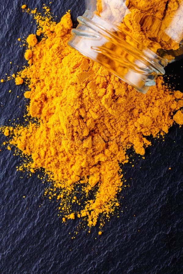 Natural Turmeric Oil in a Glass Bottle with Ground Turmeric Powder and ...