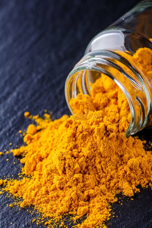 Natural Turmeric Oil in a Glass Bottle with Ground Turmeric Powder and ...