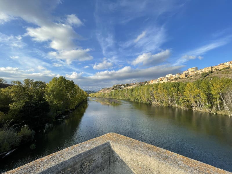 Natural View of a Calm River and Forest Under a Wispy Sky Stock Image ...