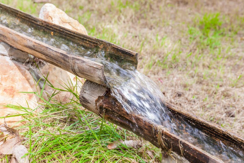 Natural Water Flowing into Bamboo Pipes. Stock Photo - Image of serene ...