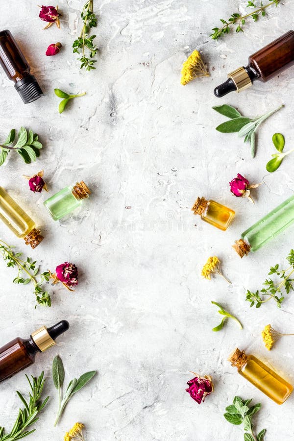 Natural Wellness. Essential Oils Near Herbs and Leaves on Grey ...