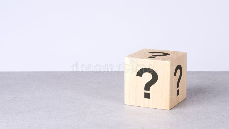 Wooden Toy Cube with a Question Marks Viewed High Angle on a Blue ...