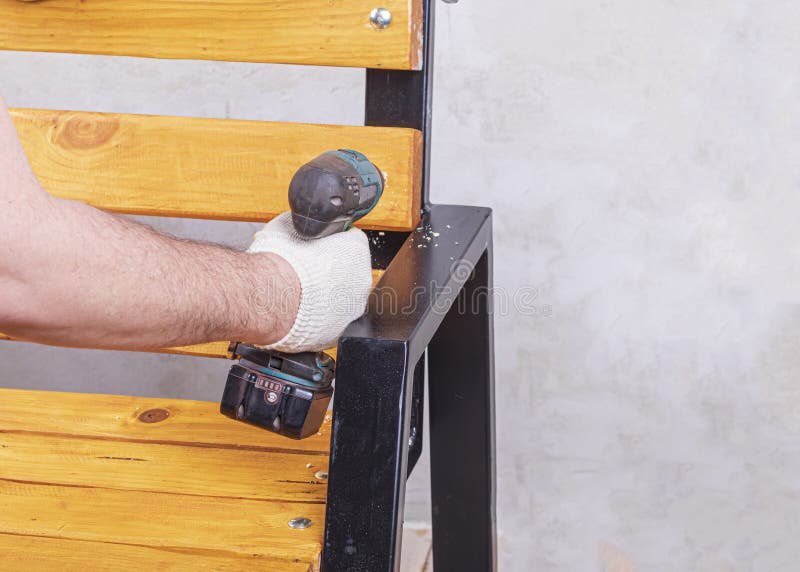 A Natural Yellow Board is Lying on a Street Bench. the Master Installs ...
