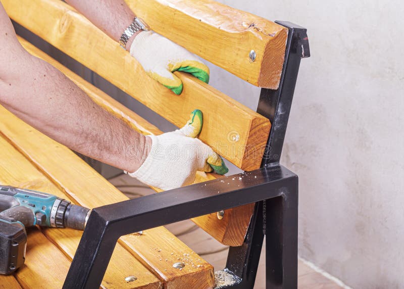 A Natural Yellow Board is Lying on a Street Bench. the Master Installs ...