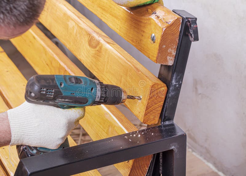 A Natural Yellow Board is Lying on a Street Bench. the Master Installs ...