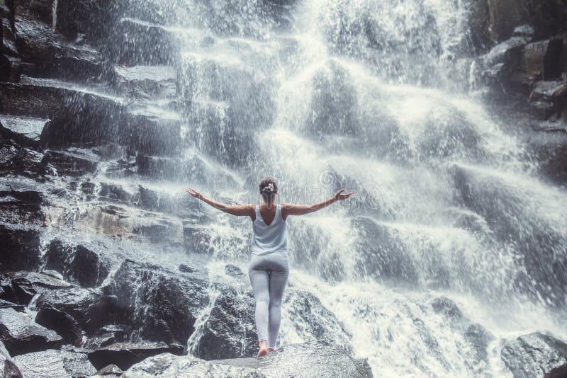 Yoga on the waterfall stock photo. Image of gymnastics - 101944208