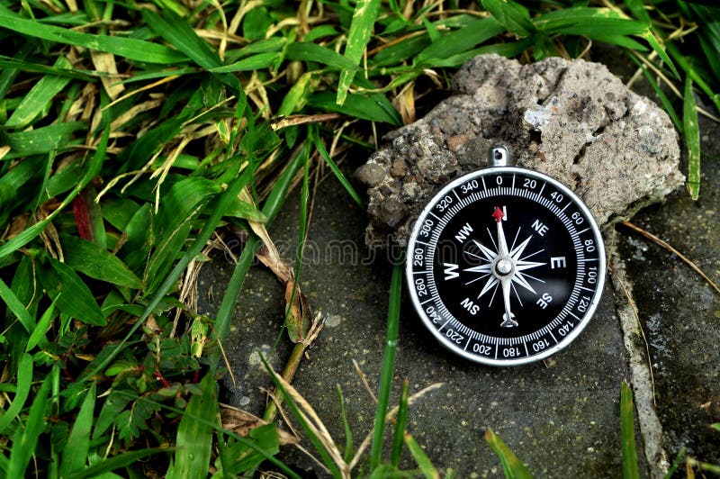 Navigation Compass in Ground with Green Grass Stock Image - Image of ...