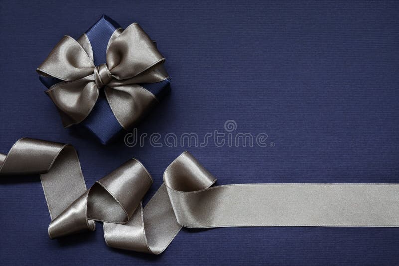 Navy Blue Gift Box Tied with Beige Ribbon on a Navy Blue Background ...