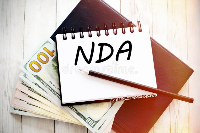 NDA Text Written on Notebook with Dollar Bills and Pencil. Financial ...