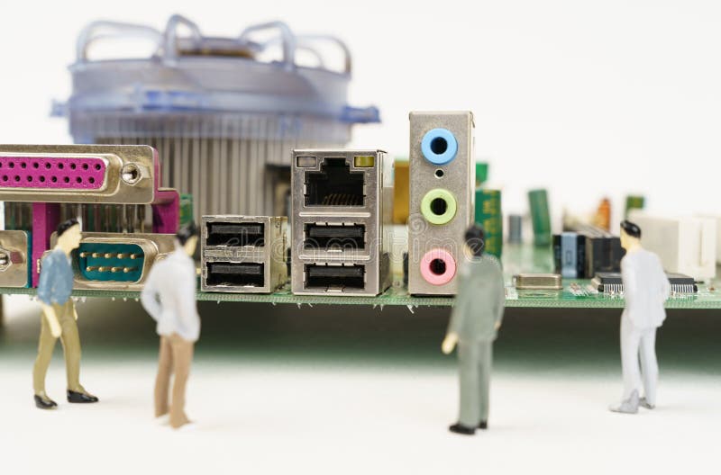 Near the Motherboard of the Computer are Miniature Figurines of People ...