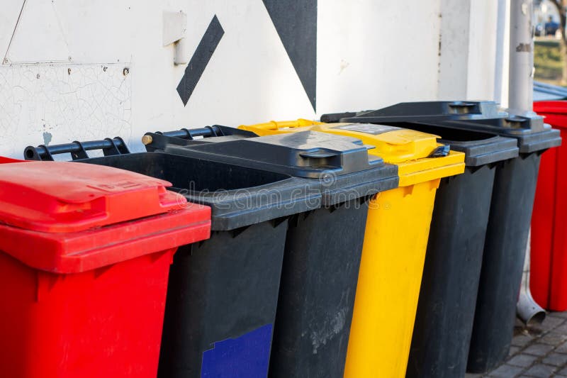 A Neat Row of Trash Cans is Lined Up Right Next To One Another Stock ...