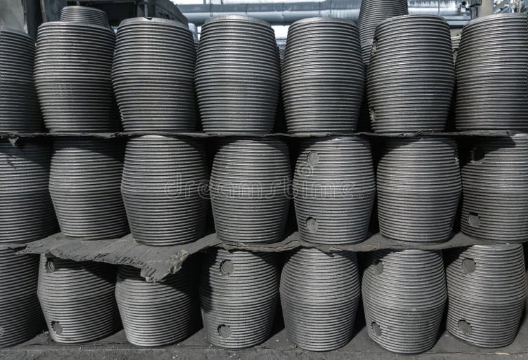 A Neat Stack of Graphite Nipples Contrasts with the Grimy Workshop Environment Stock Photo ...