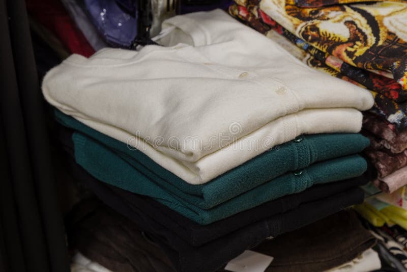 Neatly Folded Clothes in the Store on the Shelf. Stock Photo - Image of ...