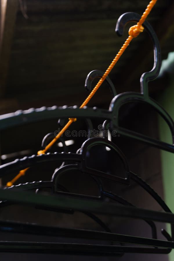 Neatly Lined Clothes Hangers on a Rope Stock Photo - Image of lined ...