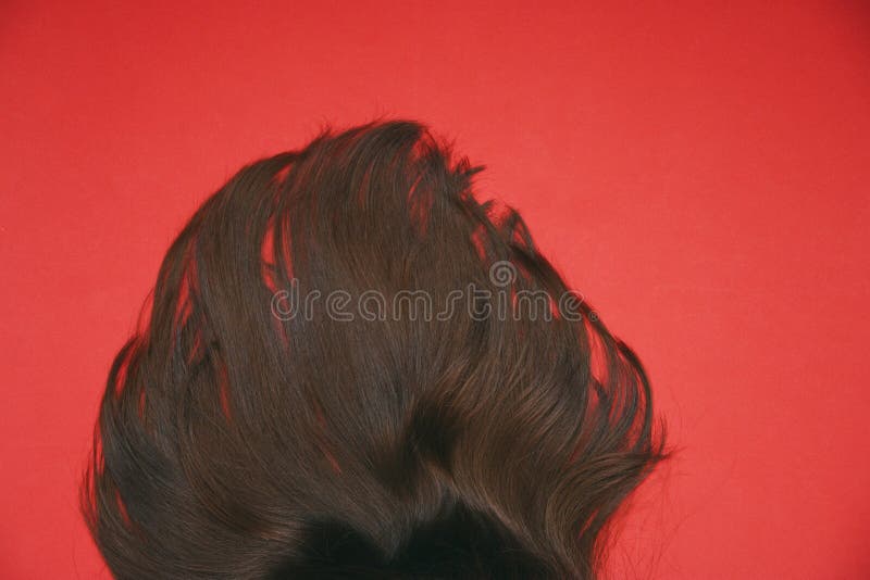 Neatly Packed Flowing Hair on a Red Background Stock Image - Image of ...