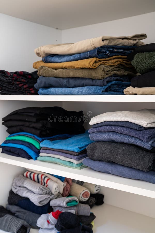 Neatly Stacked and Folded Colorful Men`s Clothes in a Closet Stock ...