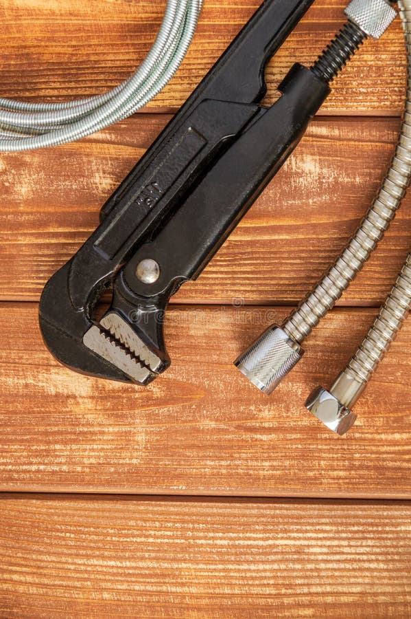 Necessary Set of Tools and Hose for Master Plumber on Old Wooden Boards ...
