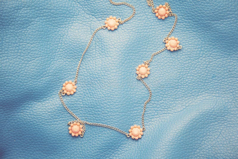 Necklace on blue texture stock image. Image of beautiful - 107919155