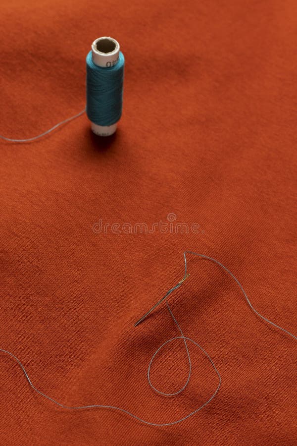 A Needle with Blue Thread on Orange Fabric. Stock Image - Image of ...