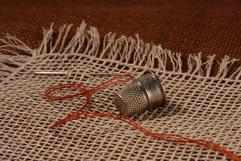 Needle with Brown Thread and Steel Thimble on Natural Linen Texture for ...