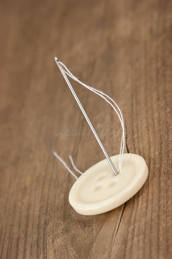 Needle and a button stock photo. Image of button, fiber - 133552796