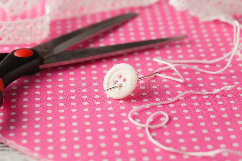 Needle and Button on Pink Polka Dot Cloth Stock Photo - Image of hobby ...