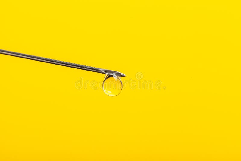 Needle With A Drop And A Smile On Yellow Background. Drugs From Syringe ...