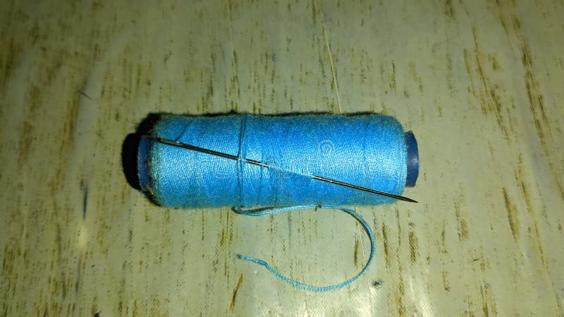 The Needle is in the Middle of the Ball of Thread Stock Image - Image ...