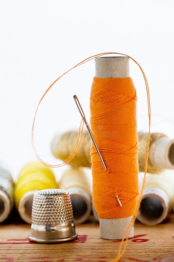 Needle with Orange Thread and Buttons Stock Image - Image of closeup ...