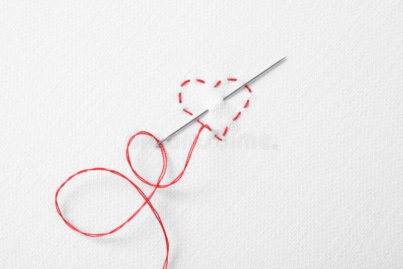 Needle with Red Thread and Stitches in Shape of Heart on White Fabric ...