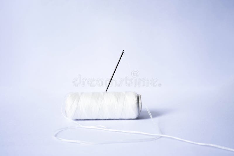 A Spool of Thread and a Needle with a Thread Stock Photo - Image of ...