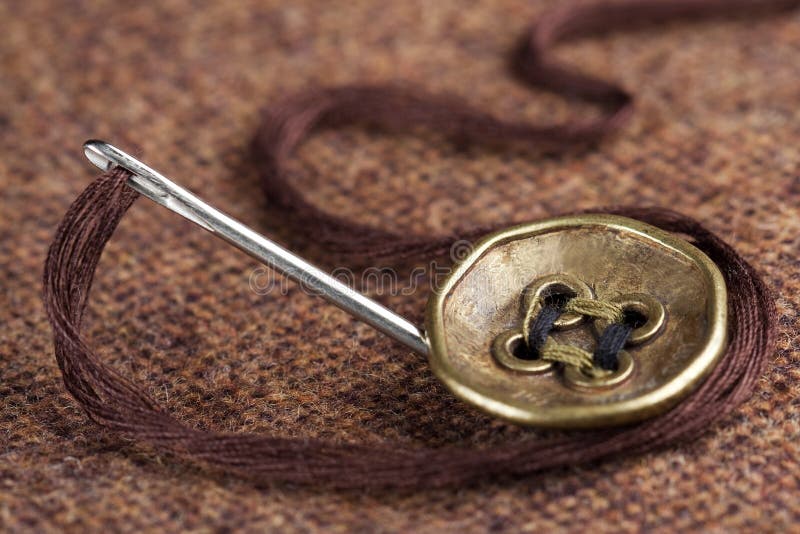 Needle with a Thread and a Button Stock Photo - Image of thread, fabric ...